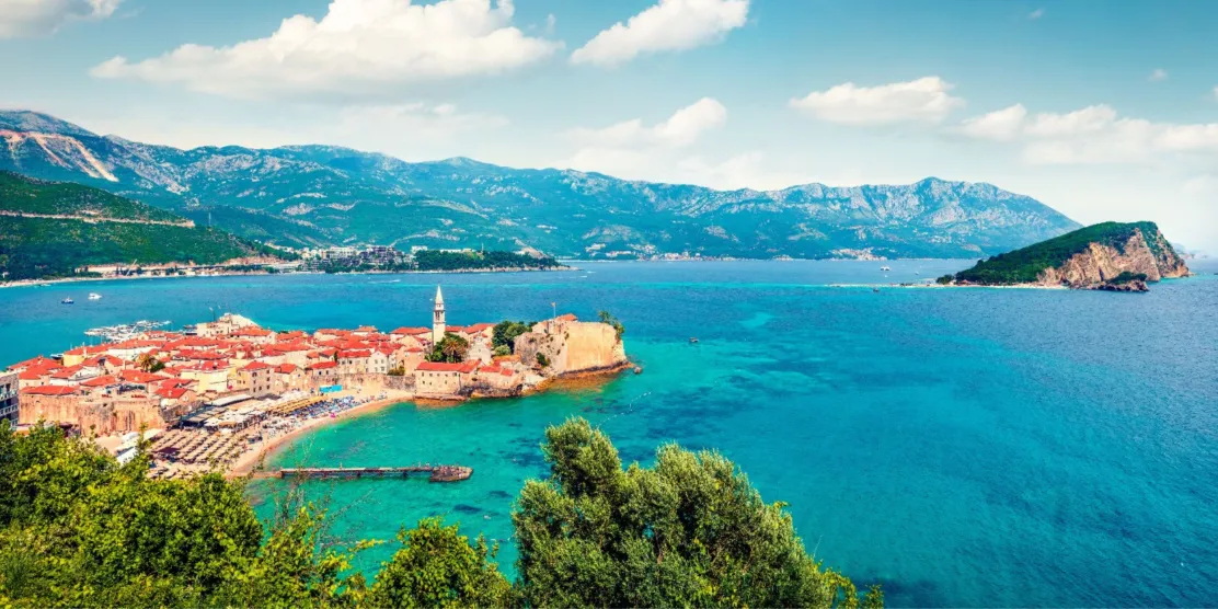 Walled town and church spire on the coast of Budva, Montenegro.