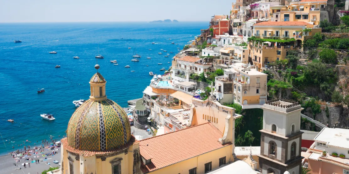 Colorful cliffside buildings overlooking the sea in Positano, Italy.