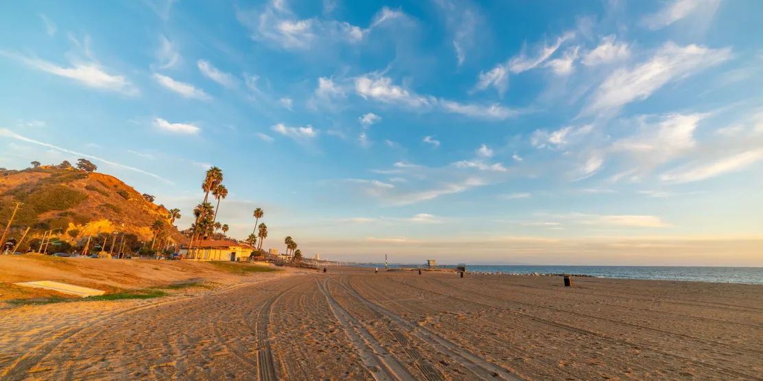 Coastal highway and rugged cliffs overlooking the ocean in Malibu, California.