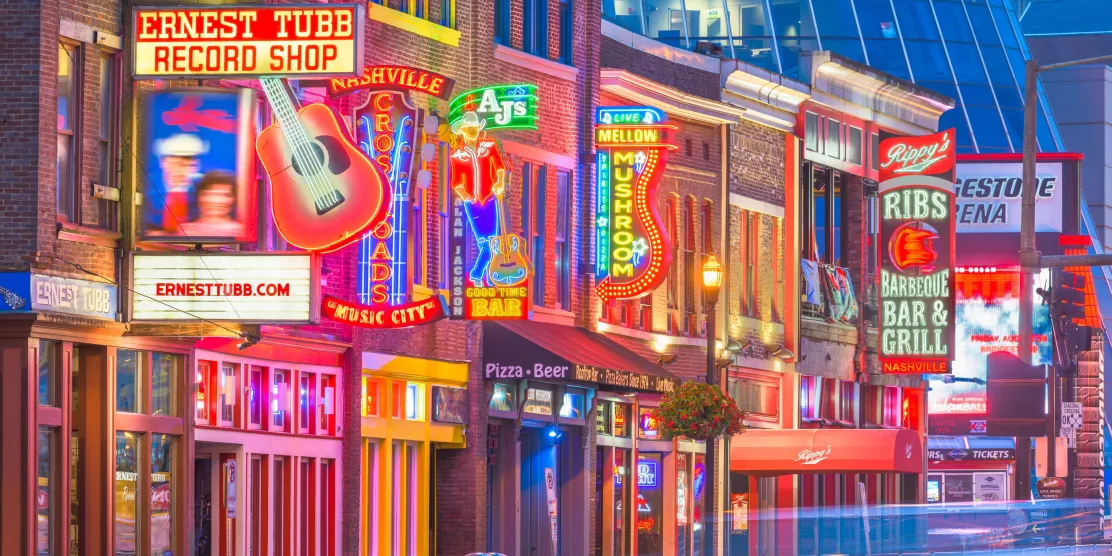 Bright neon lights and country music bars on Broadway in Nashville, Tennessee.