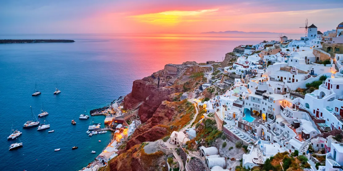 Santorini cliffside village with white houses at sunset