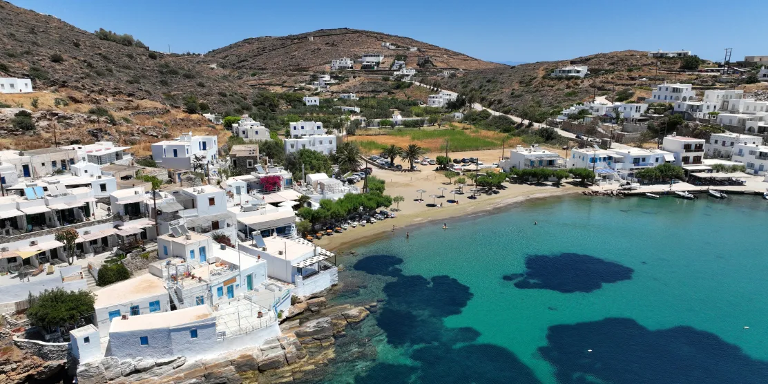 Sandy beach bay and white houses on a Mediterranean island