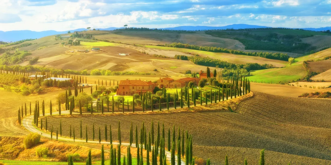 Beautiful landscape in Tuscany with winding road and cypress trees