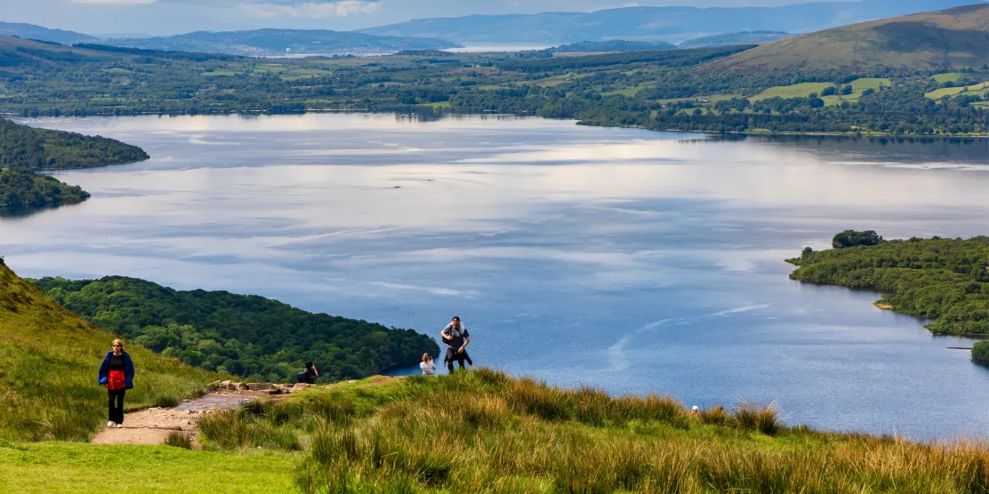 people hiking in Scottich Highlands around Loch Lomond