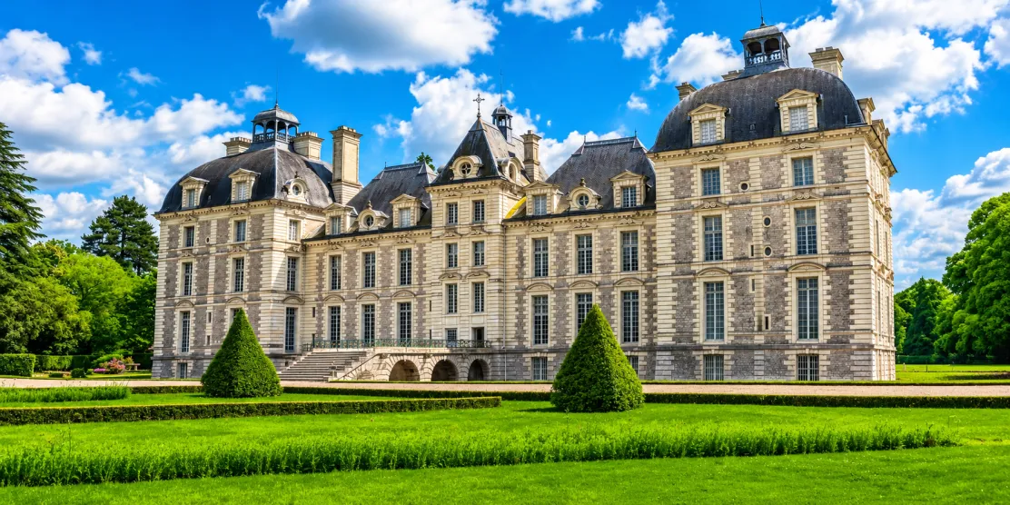 Château de Cheverny and its formal gardens under a blue sky in the Loire Valley, France