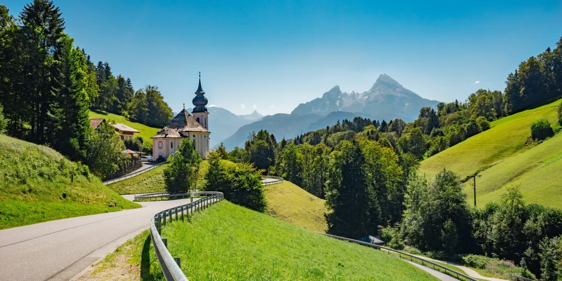 Romantic Road trip route in Germany, with a scenic country road through the Bavarian Alps