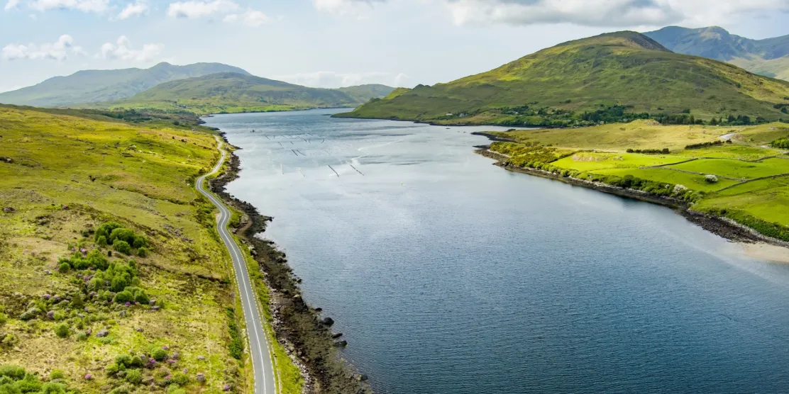 Wild Atlantic Way road trip route in Ireland, with a scenic coastal road between mountains and the Atlantic coast