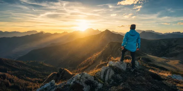 cover photo of the article best hikes in Europe showing a man during a hike on a top of a mountain